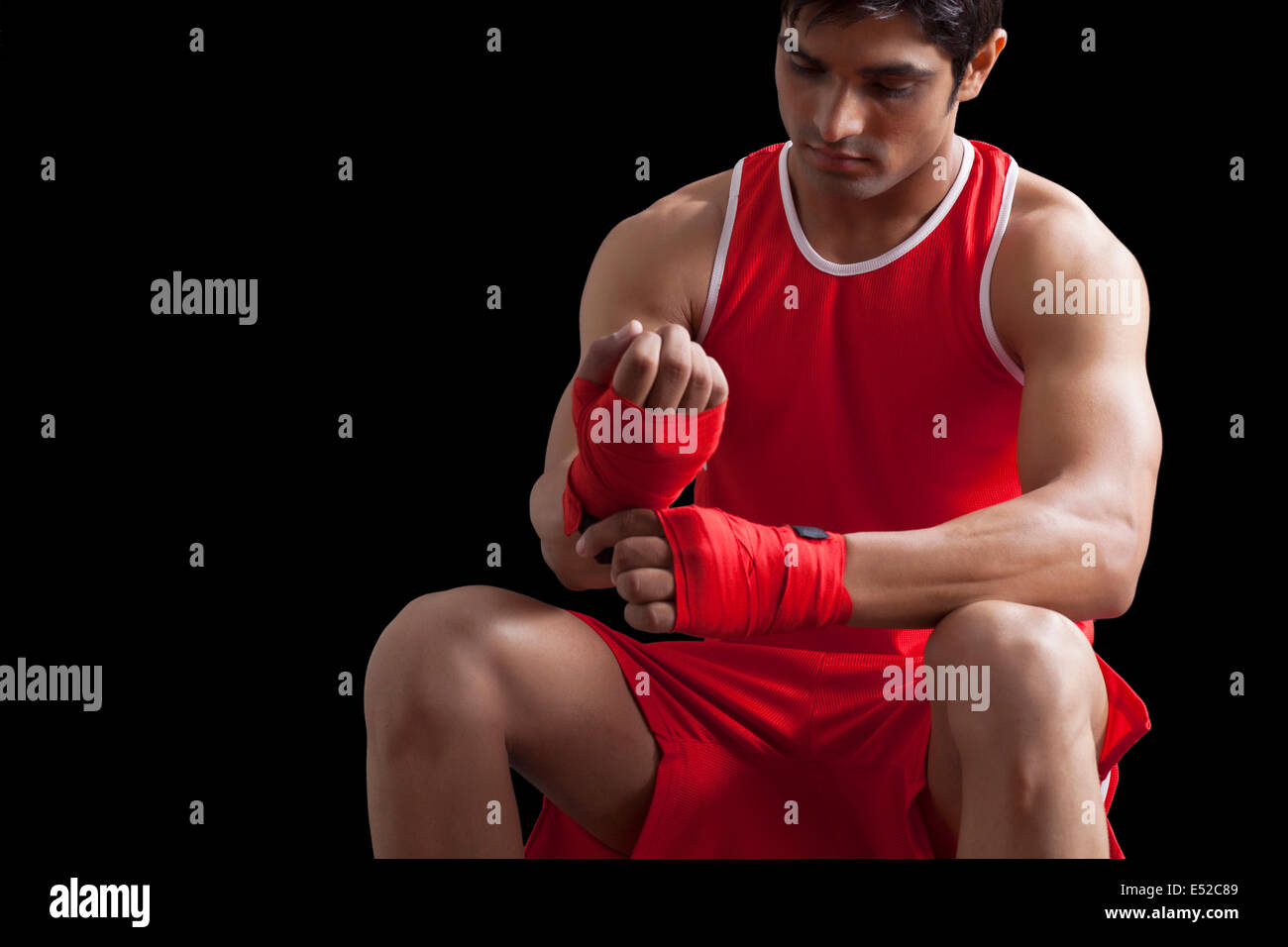 Male boxer taping up hands over black background Stock Photo - Alamy