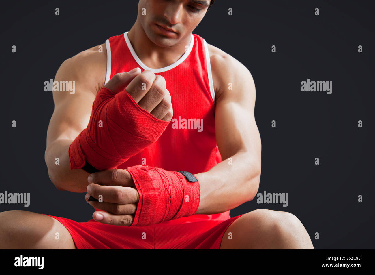 Male boxer taping up hands over black background Stock Photo - Alamy