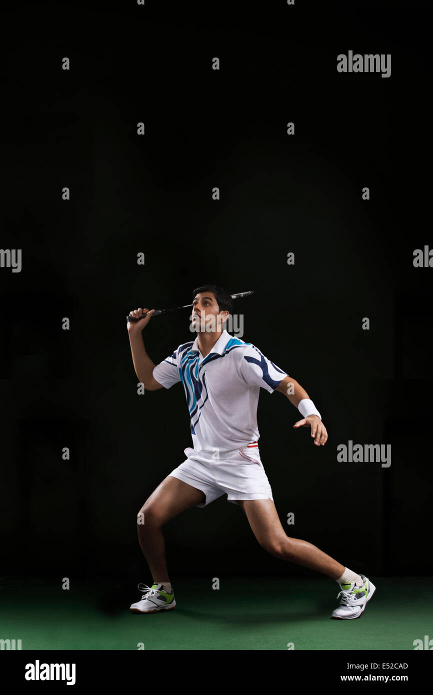 Full length of man playing badminton at court Stock Photo - Alamy