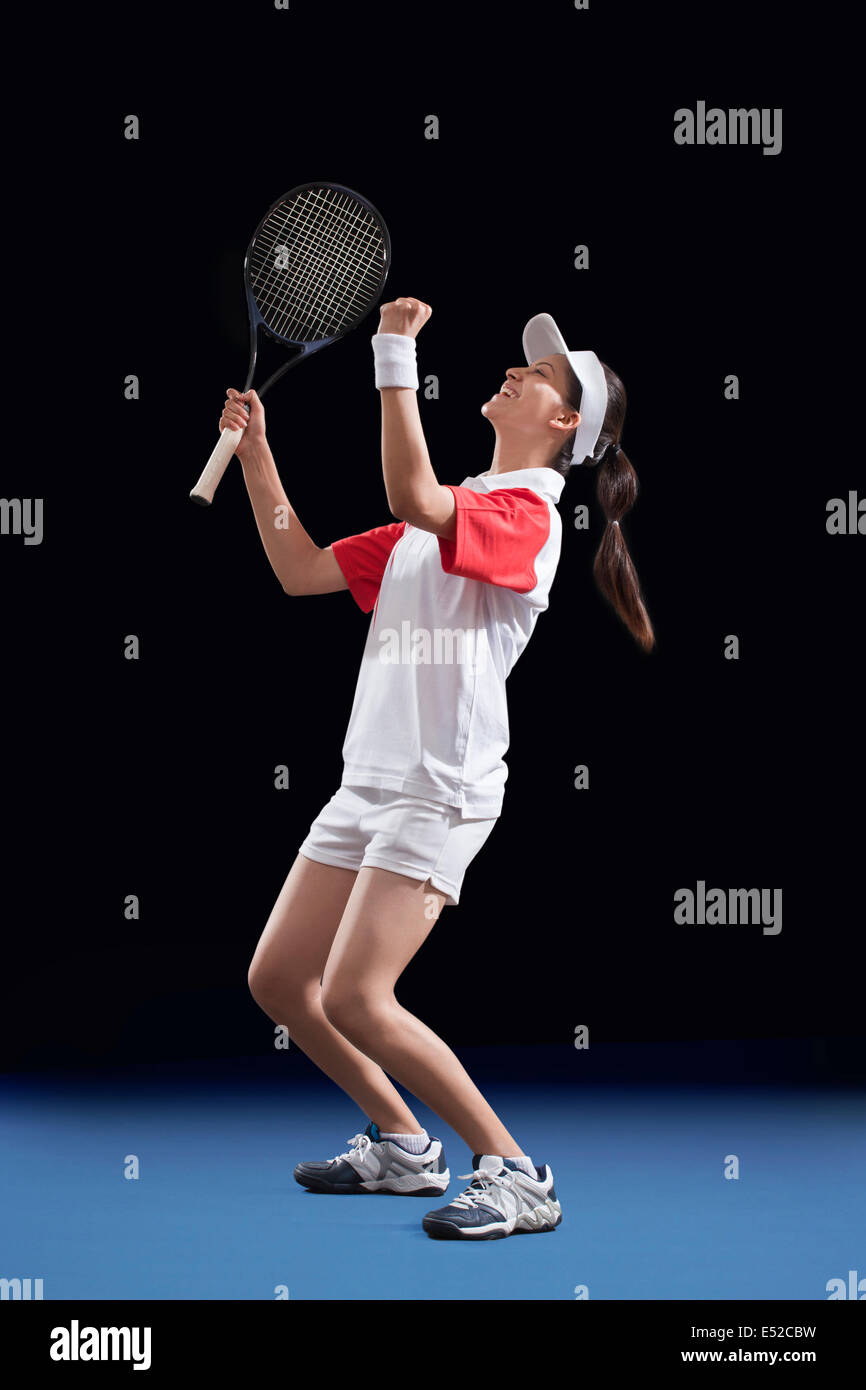 Female tennis player celebrating victory at court Stock Photo - Alamy