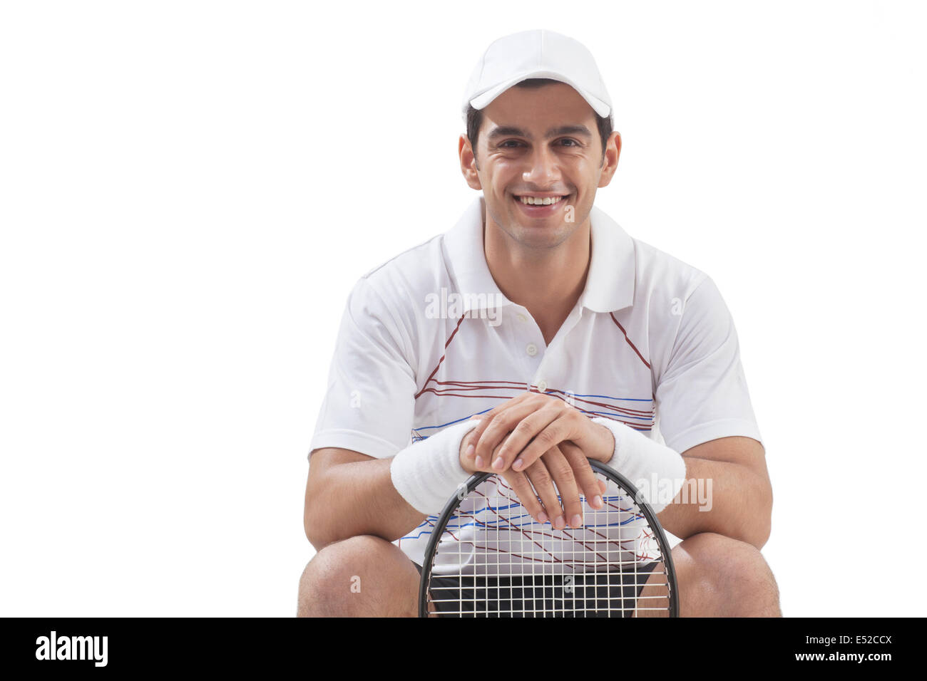 Portrait of young man with tennis racket isolated over white background ...