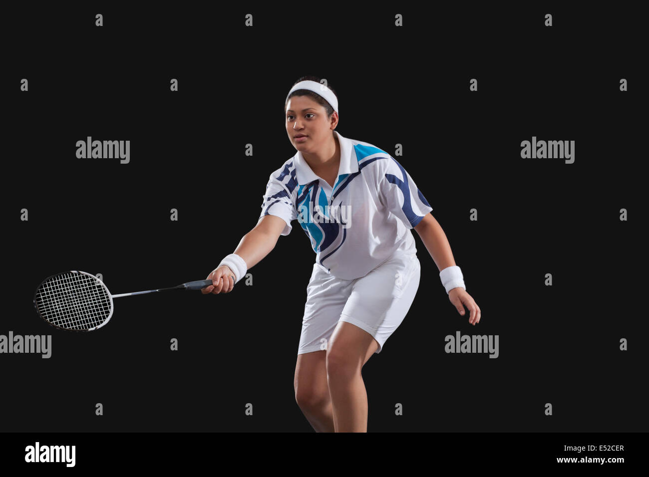 Young woman playing badminton over black background Stock Photo - Alamy