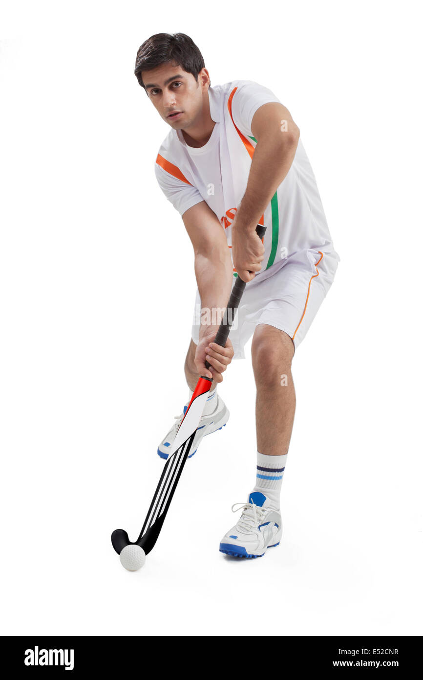 Portrait of young man playing field hockey isolated over white ...