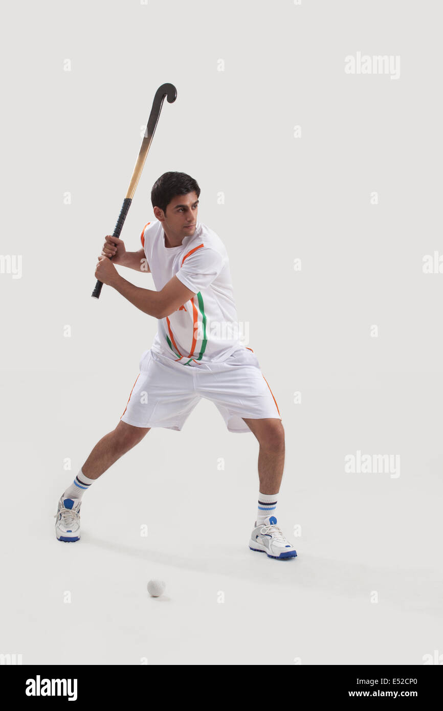 Young man playing field hockey isolated over white background Stock ...