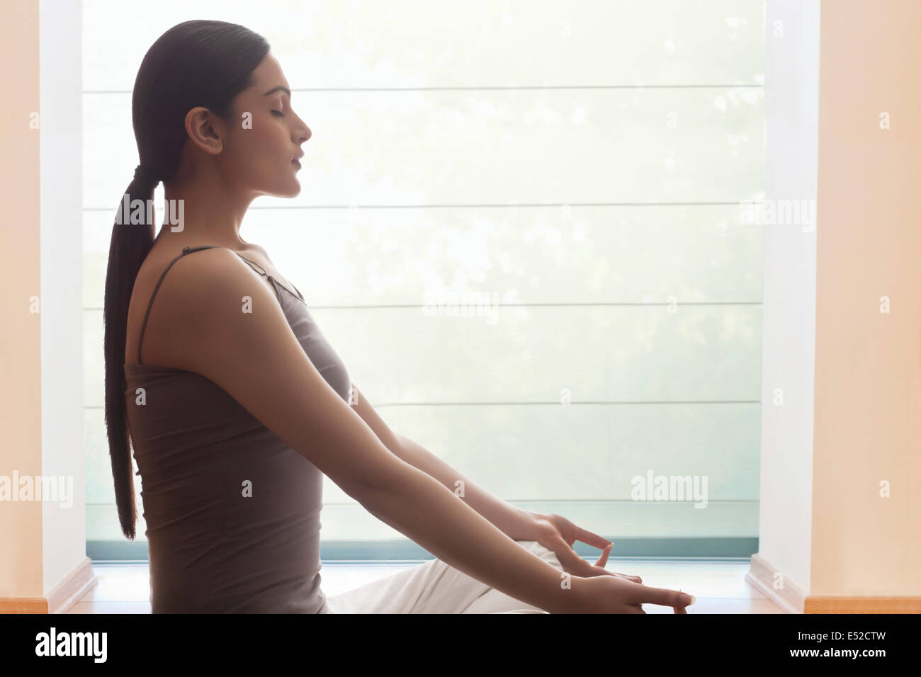 Young indian woman meditating sitting hi-res stock photography and ...