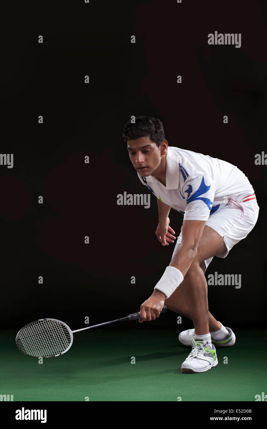 Young man in sportswear playing badminton over black background Stock ...