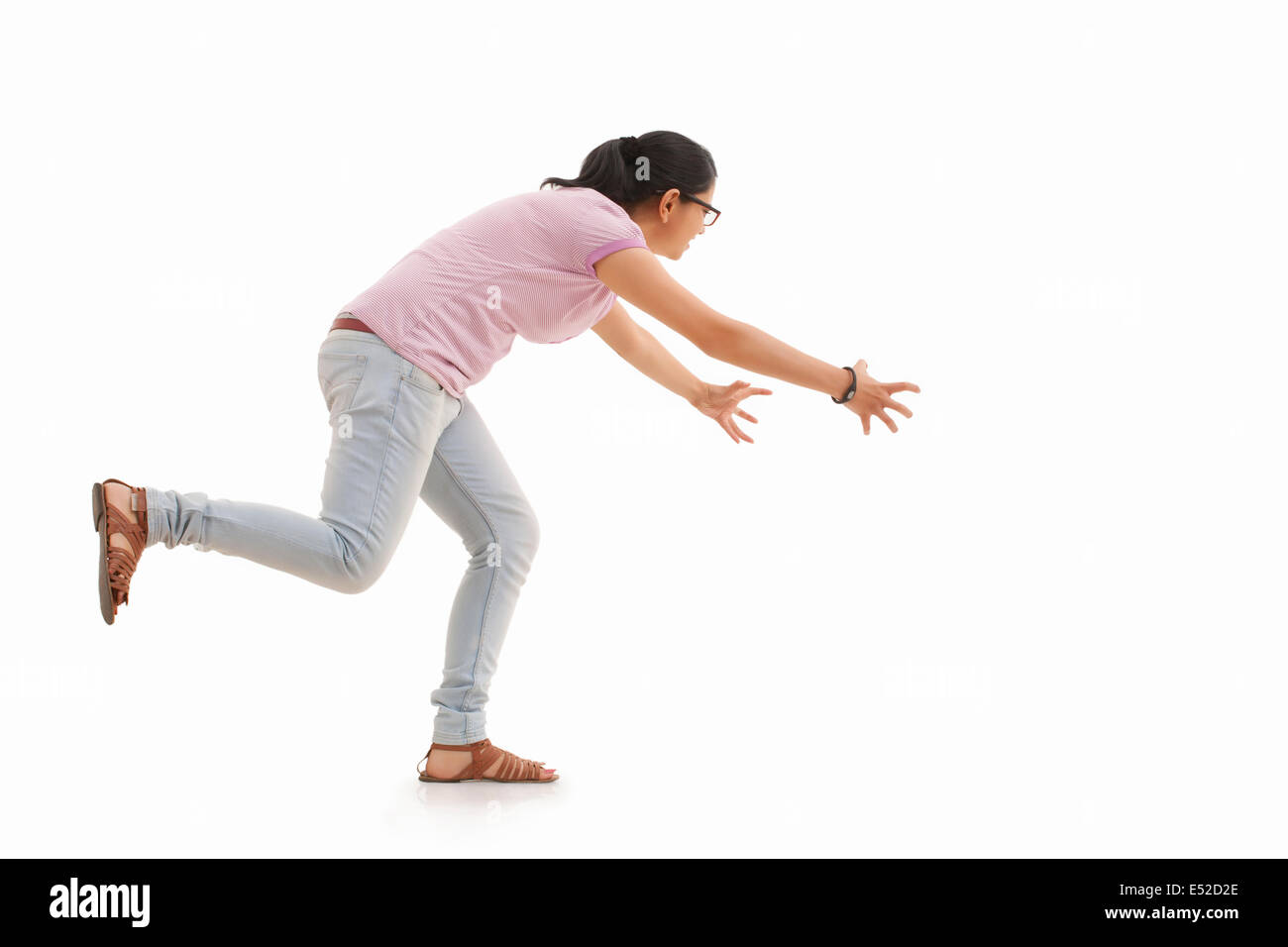 Young woman trying to catch Stock Photo - Alamy