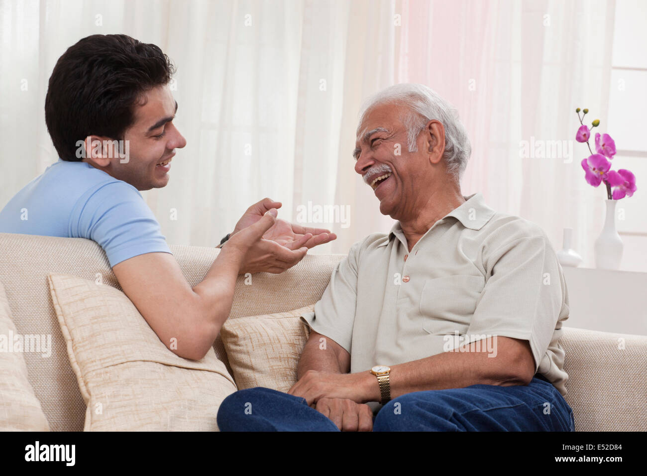 Grandson and grandfather talking Stock Photo - Alamy