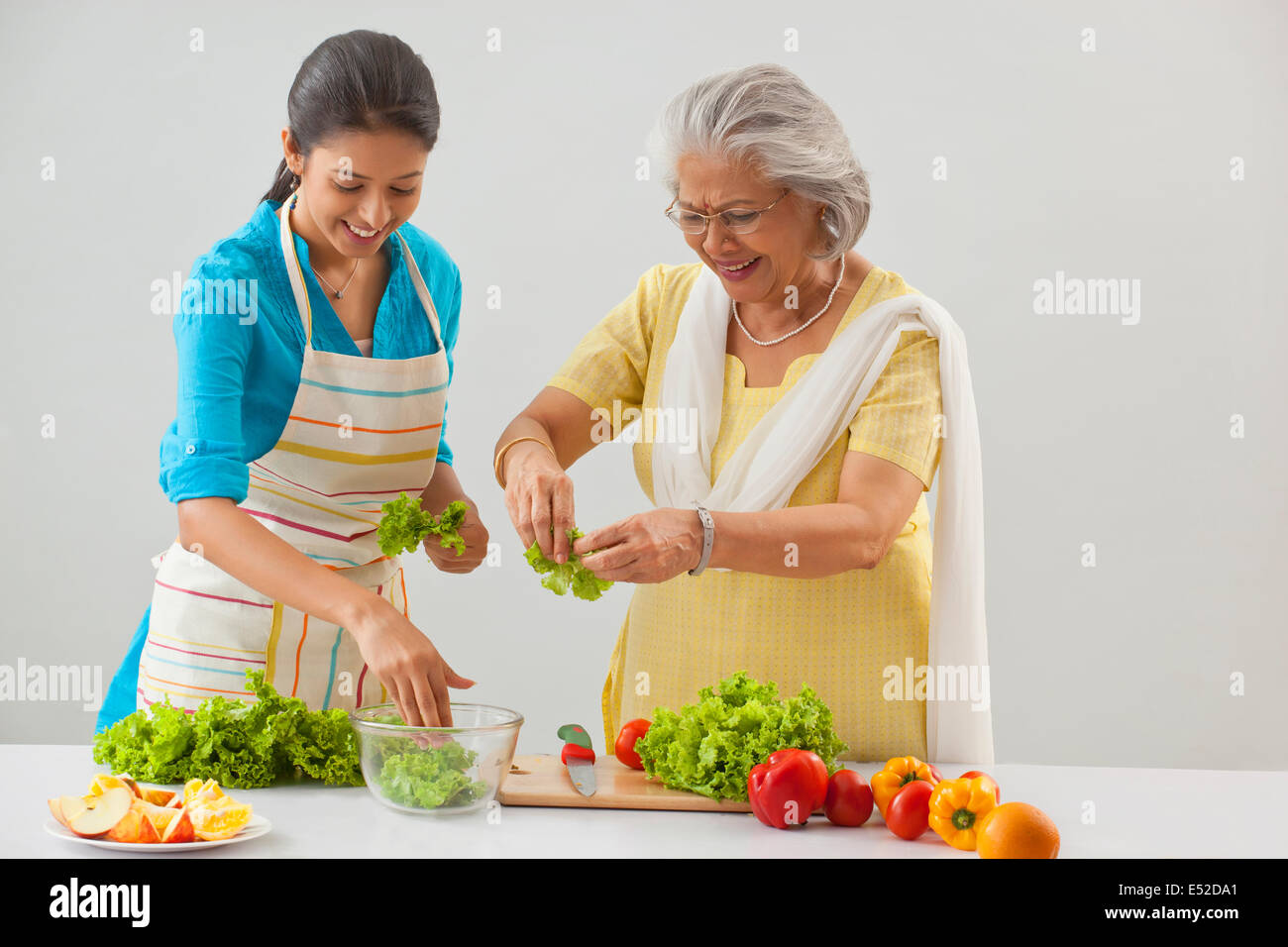 Grandmother and granddaughter working in the kitchen Stock Photo - Alamy