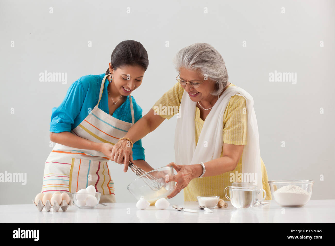 Grandmother and granddaughter working in the kitchen Stock Photo - Alamy