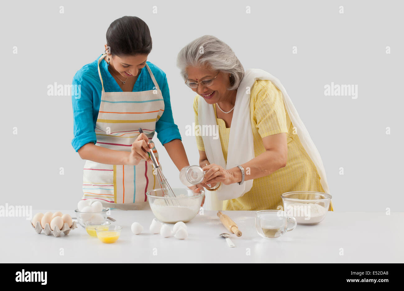 Grandmother and granddaughter working in the kitchen Stock Photo - Alamy