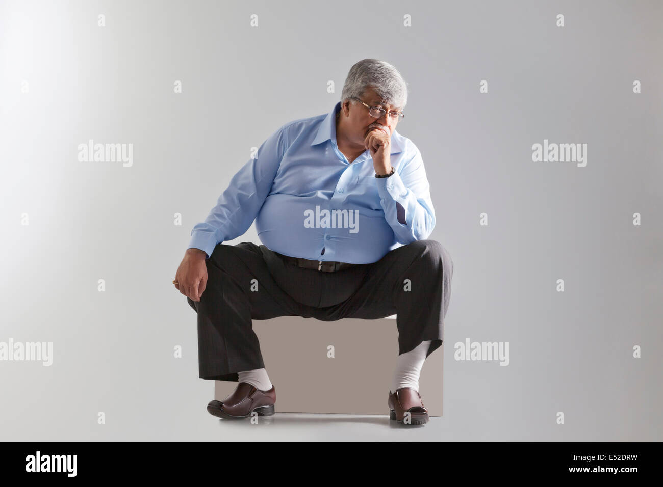 Obese old man thinking Stock Photo - Alamy