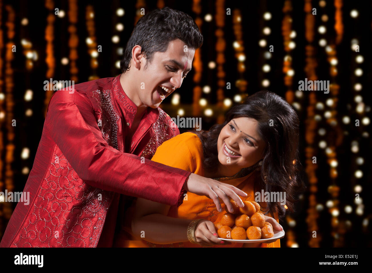 Man trying to take sweets from woman Stock Photo - Alamy