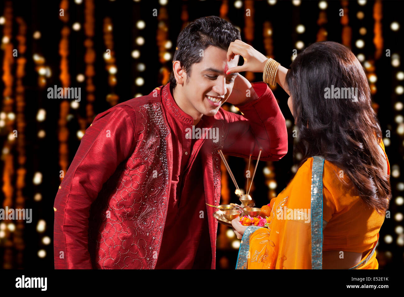 Woman putting tika on a man Stock Photo - Alamy