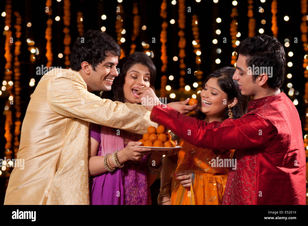Friends eating sweets Stock Photo - Alamy