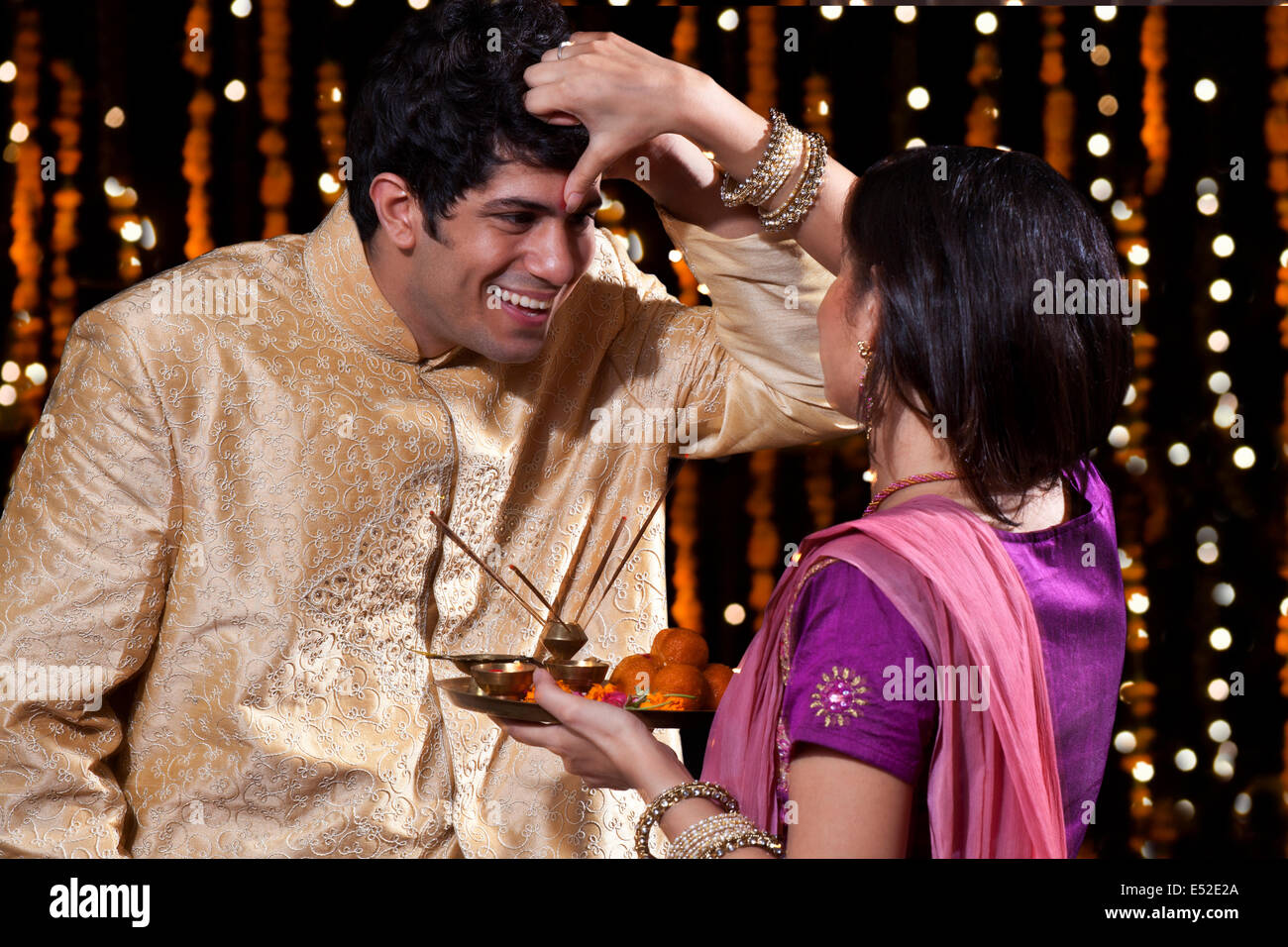 Woman putting tika on a man Stock Photo - Alamy