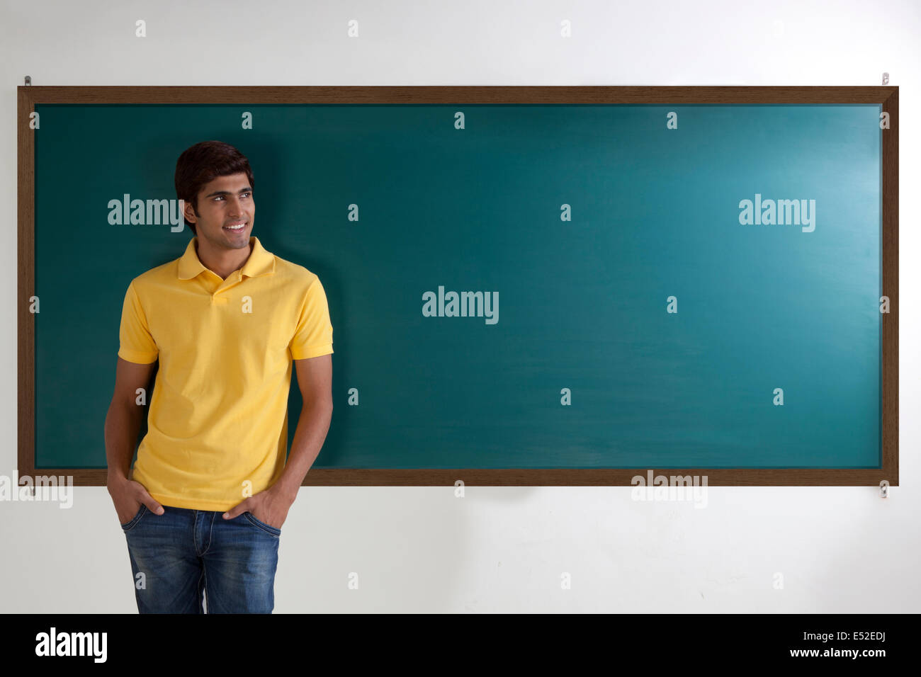 College student standing in front of blackboard Stock Photo - Alamy