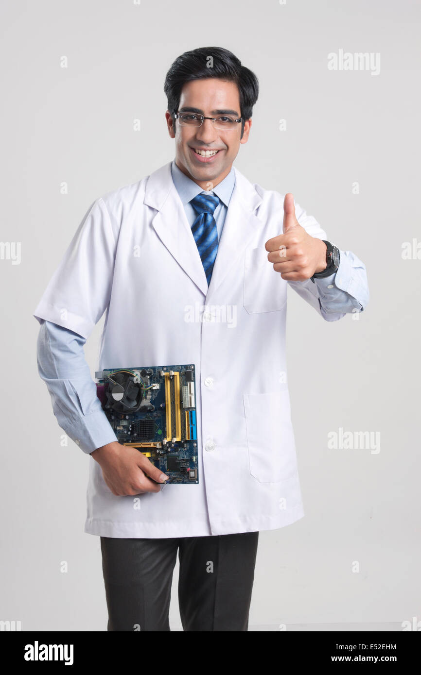 Portrait of happy male technician gesturing thumbs up while holding ...