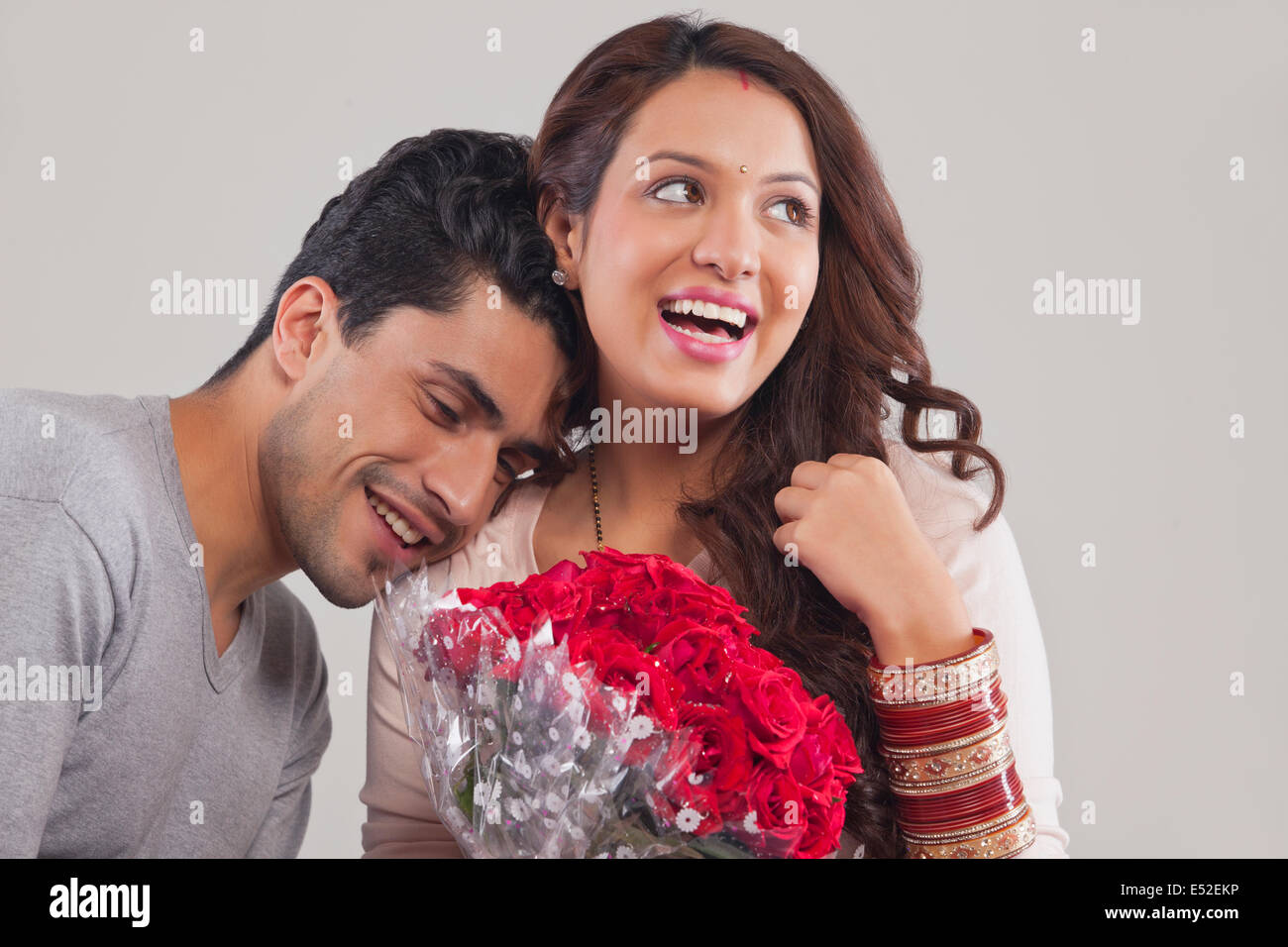 Couple with a bouquet of flowers Stock Photo - Alamy