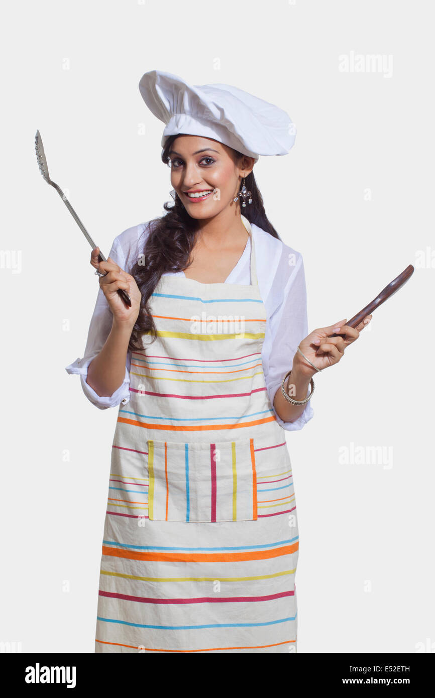 Portrait of a female chef with cooking utensils Stock Photo - Alamy