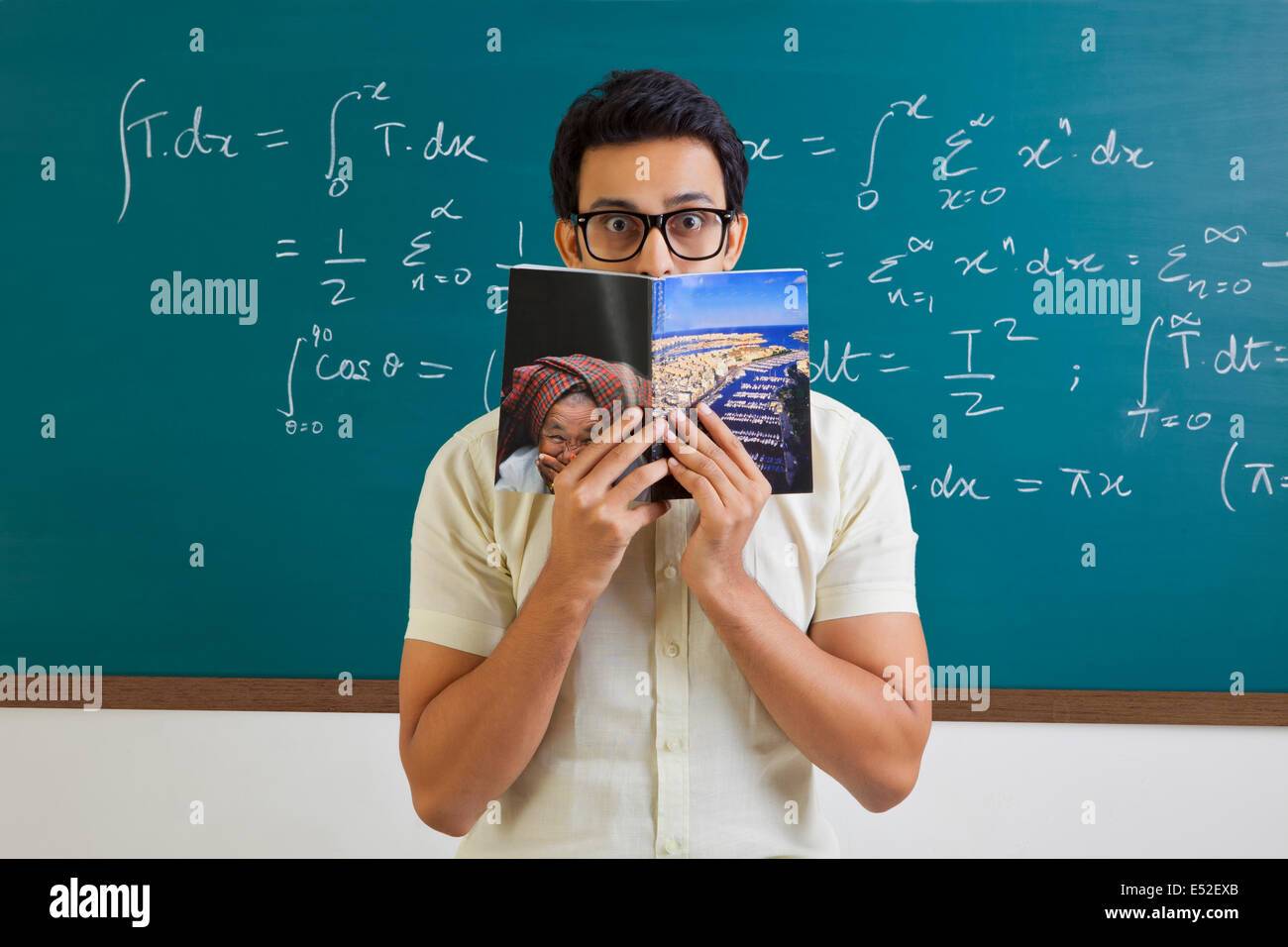 Portrait of college student hiding face with a book Stock Photo - Alamy