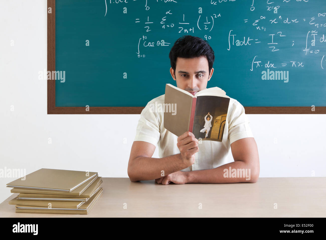 College student reading a book Stock Photo - Alamy