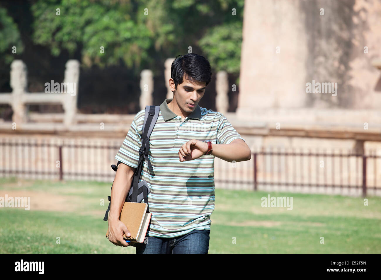 Student checking his watch Stock Photo - Alamy