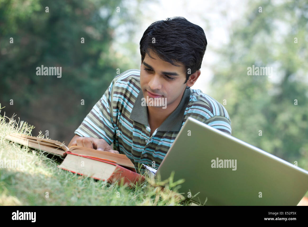 Student reading a book in a park Stock Photo - Alamy
