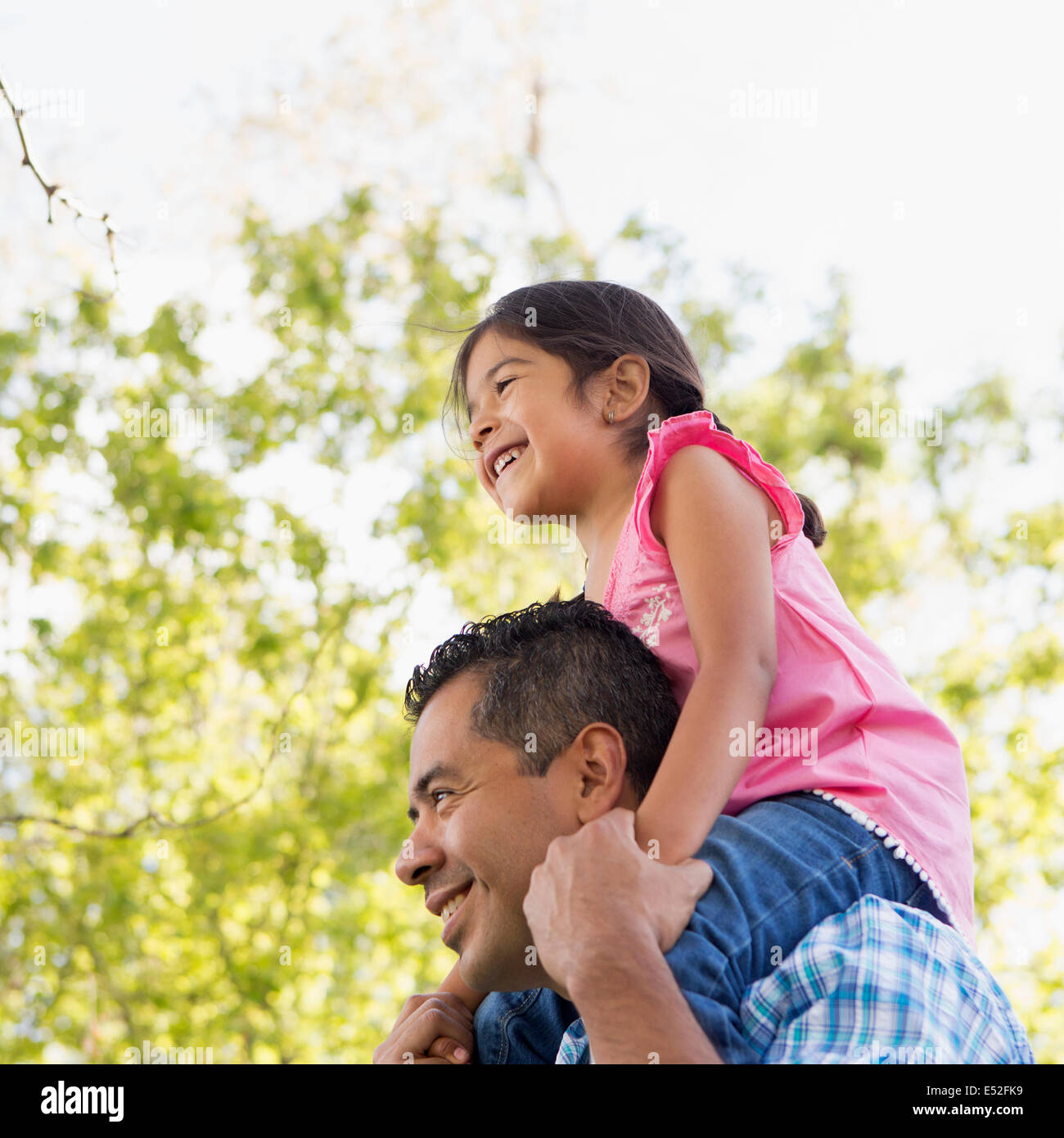 A man giving his daughter a piggyback ride on his shoulders Stock Photo ...