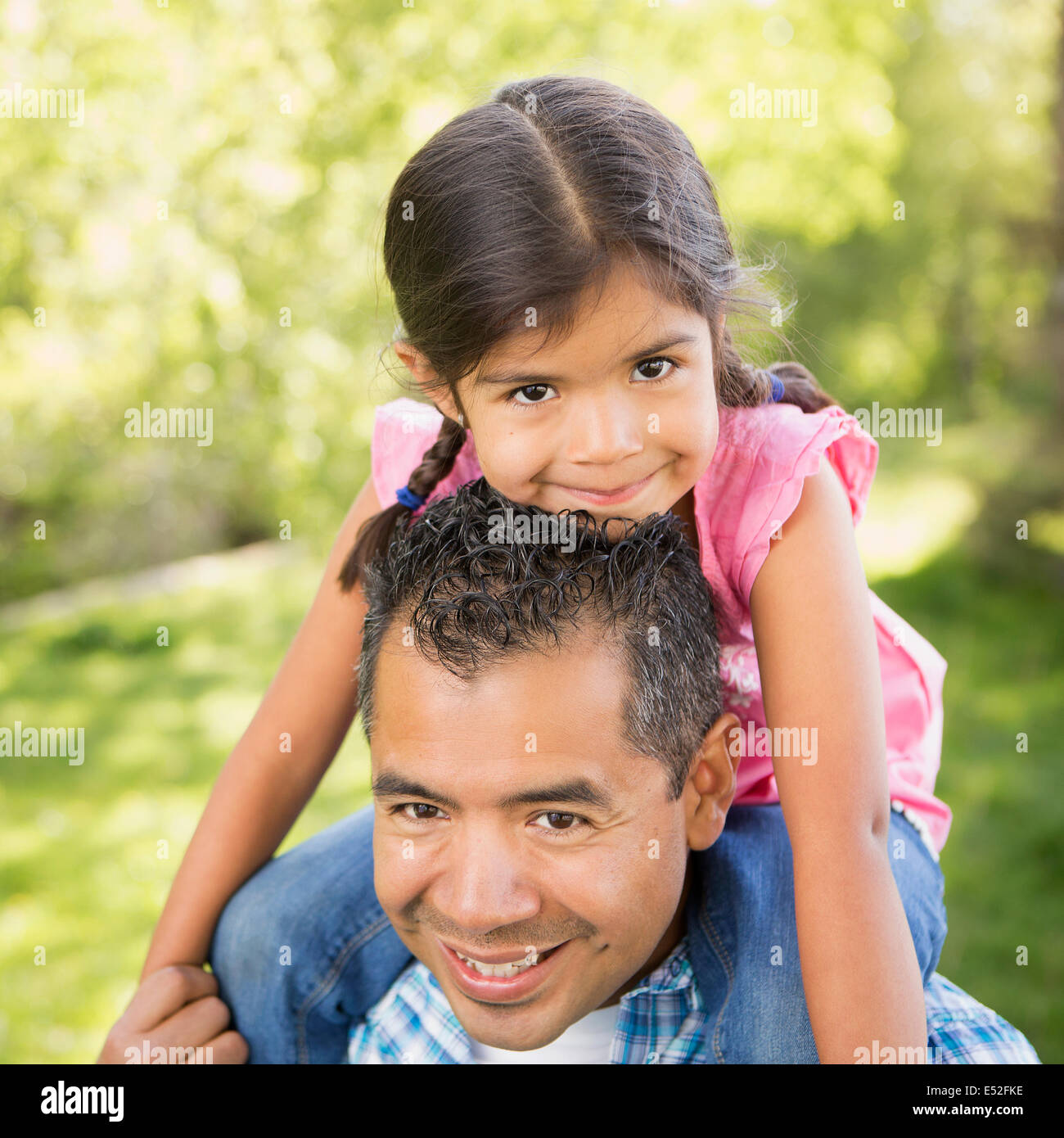 A man giving his daughter a piggyback ride on his shoulders Stock Photo ...