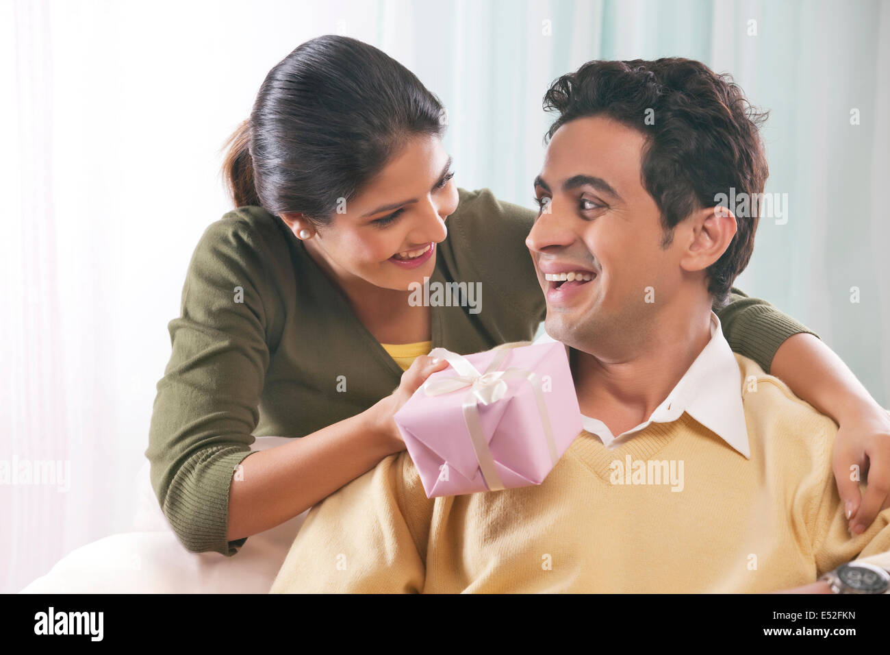 Woman giving a man a gift on Valentines Day Stock Photo - Alamy