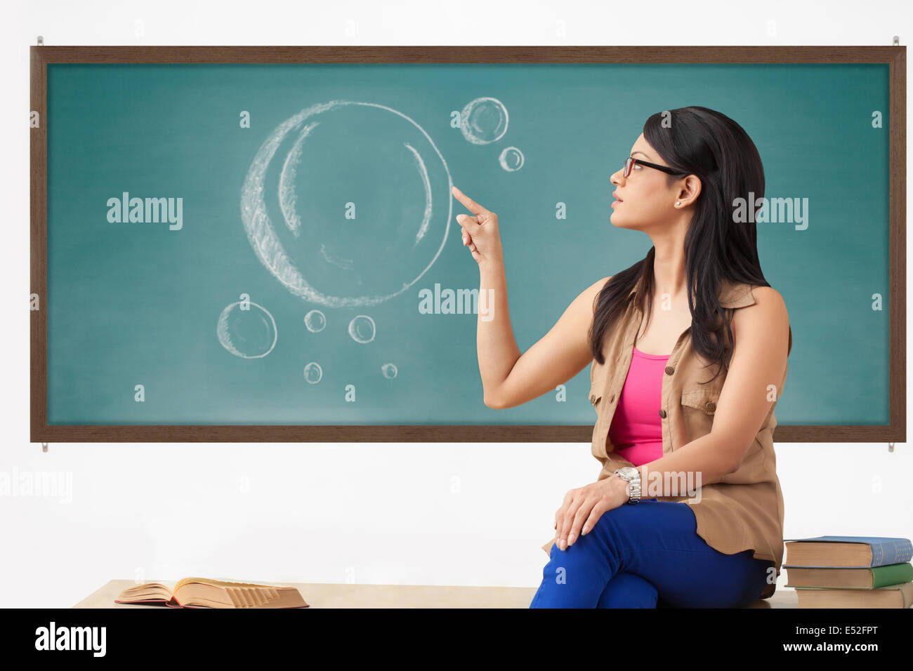 Female college student pointing at blackboard Stock Photo - Alamy