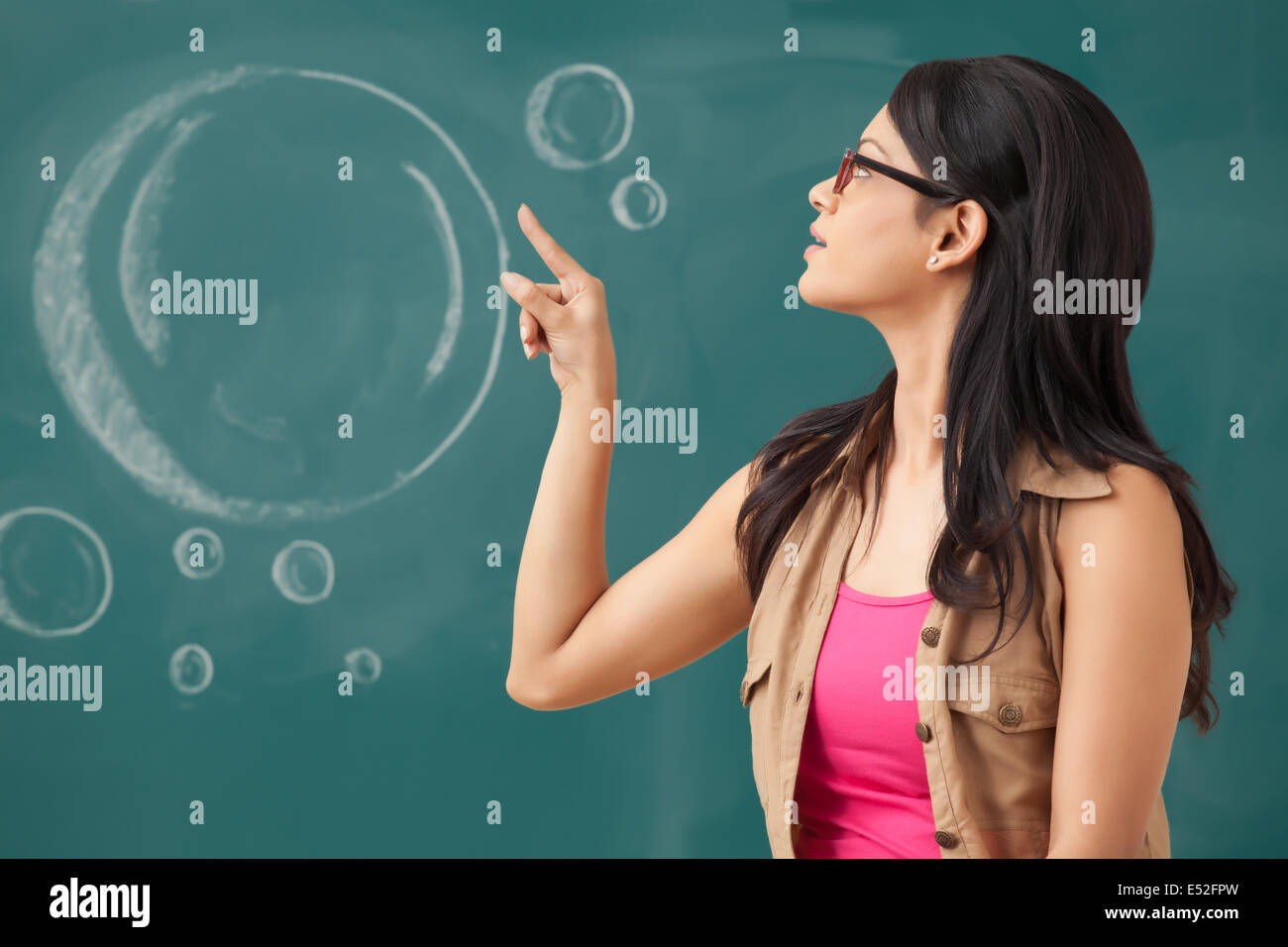 Female college student pointing at blackboard Stock Photo - Alamy