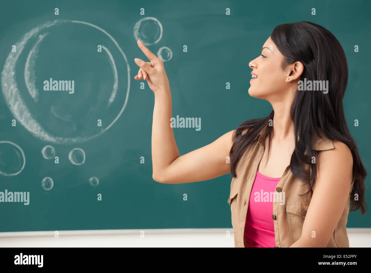 Female college student pointing at blackboard Stock Photo - Alamy