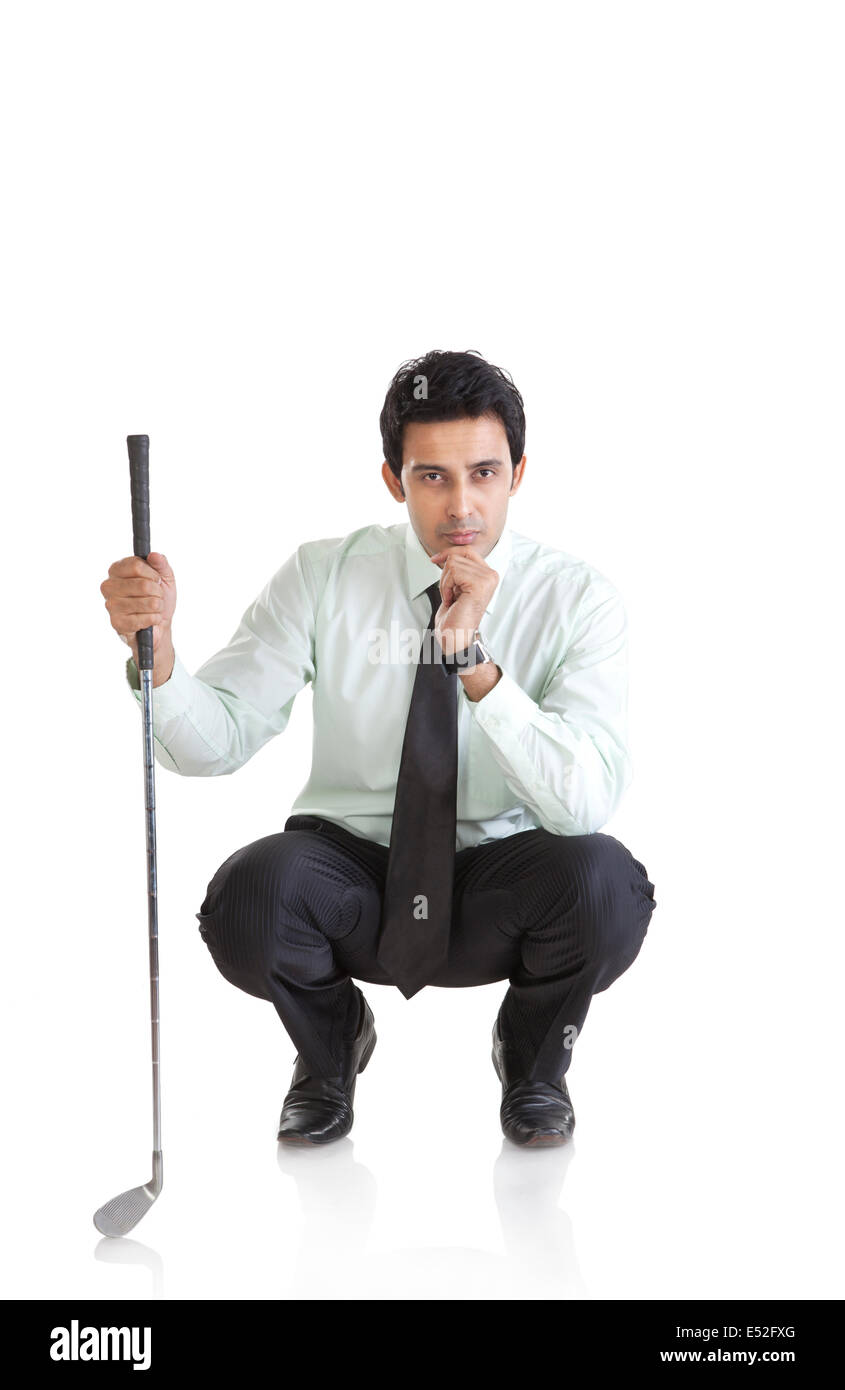 Portrait of business executive with golf club thinking Stock Photo - Alamy