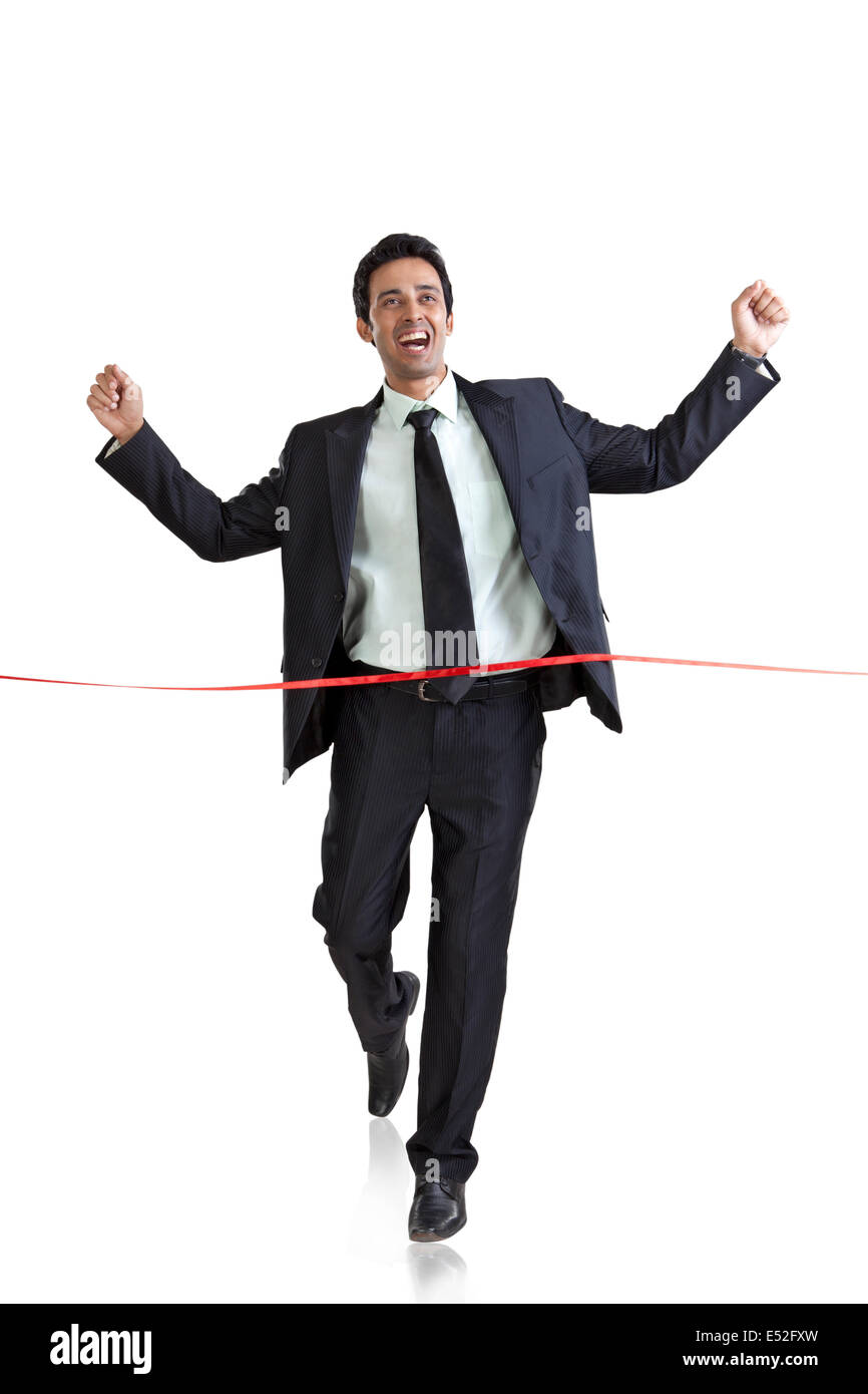 Business executive crossing the finish line Stock Photo - Alamy