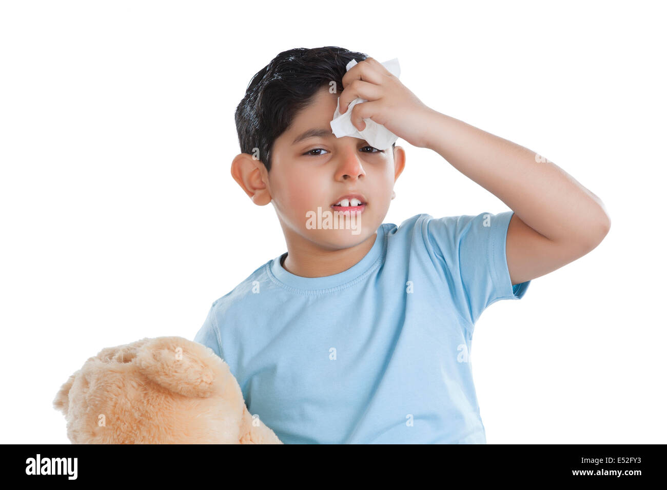 Portrait of little boy putting ice on forehead Stock Photo - Alamy