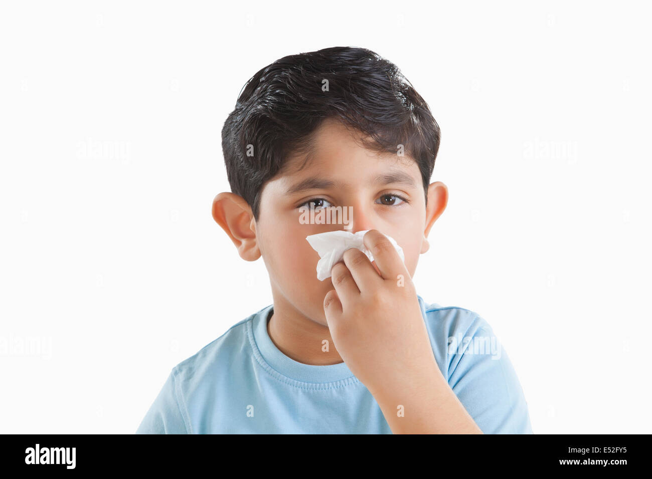 Portrait of little boy with tissue over nose Stock Photo - Alamy