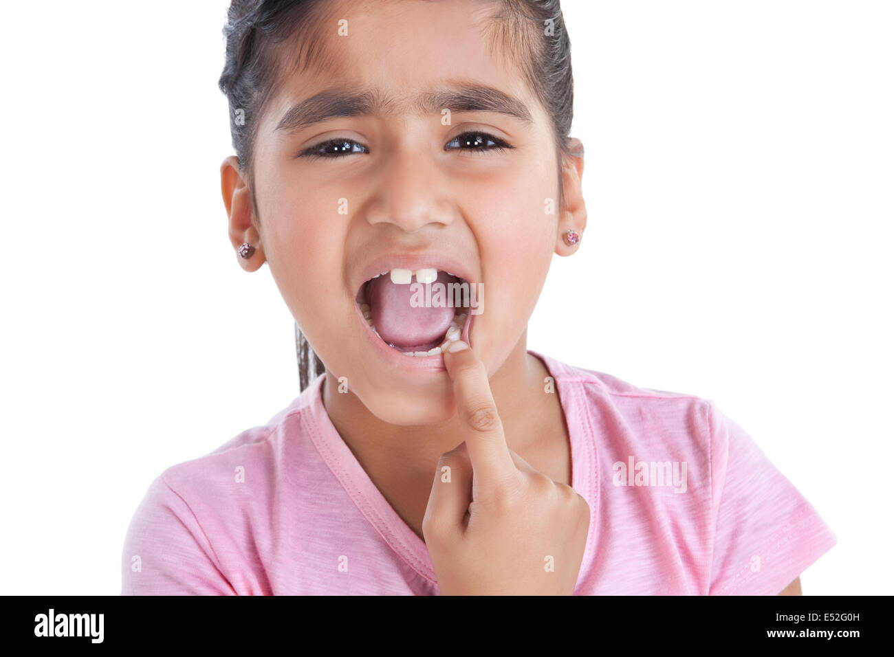 Portrait of little girl showing her teeth Stock Photo - Alamy