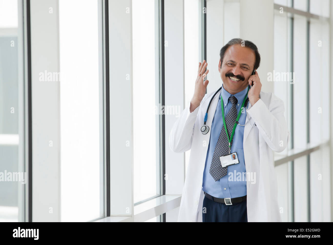 Doctor talking on a mobile phone Stock Photo - Alamy