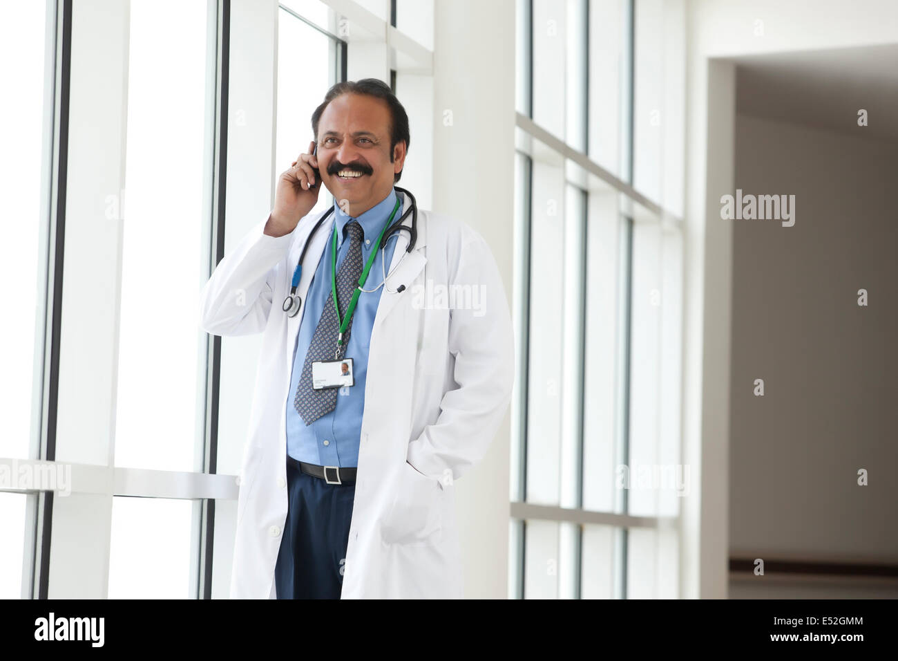 Doctor talking on a mobile phone Stock Photo - Alamy
