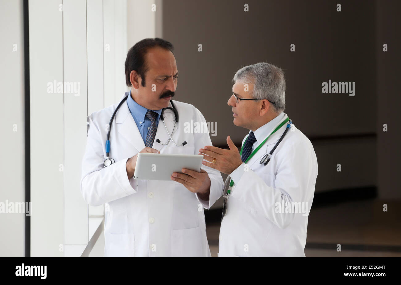 Two doctors talking in corridor of hospital Stock Photo - Alamy