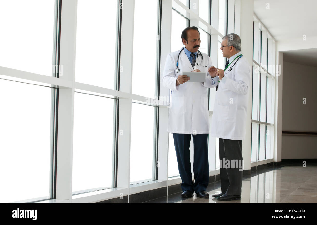 Two doctors talking in corridor of hospital Stock Photo - Alamy