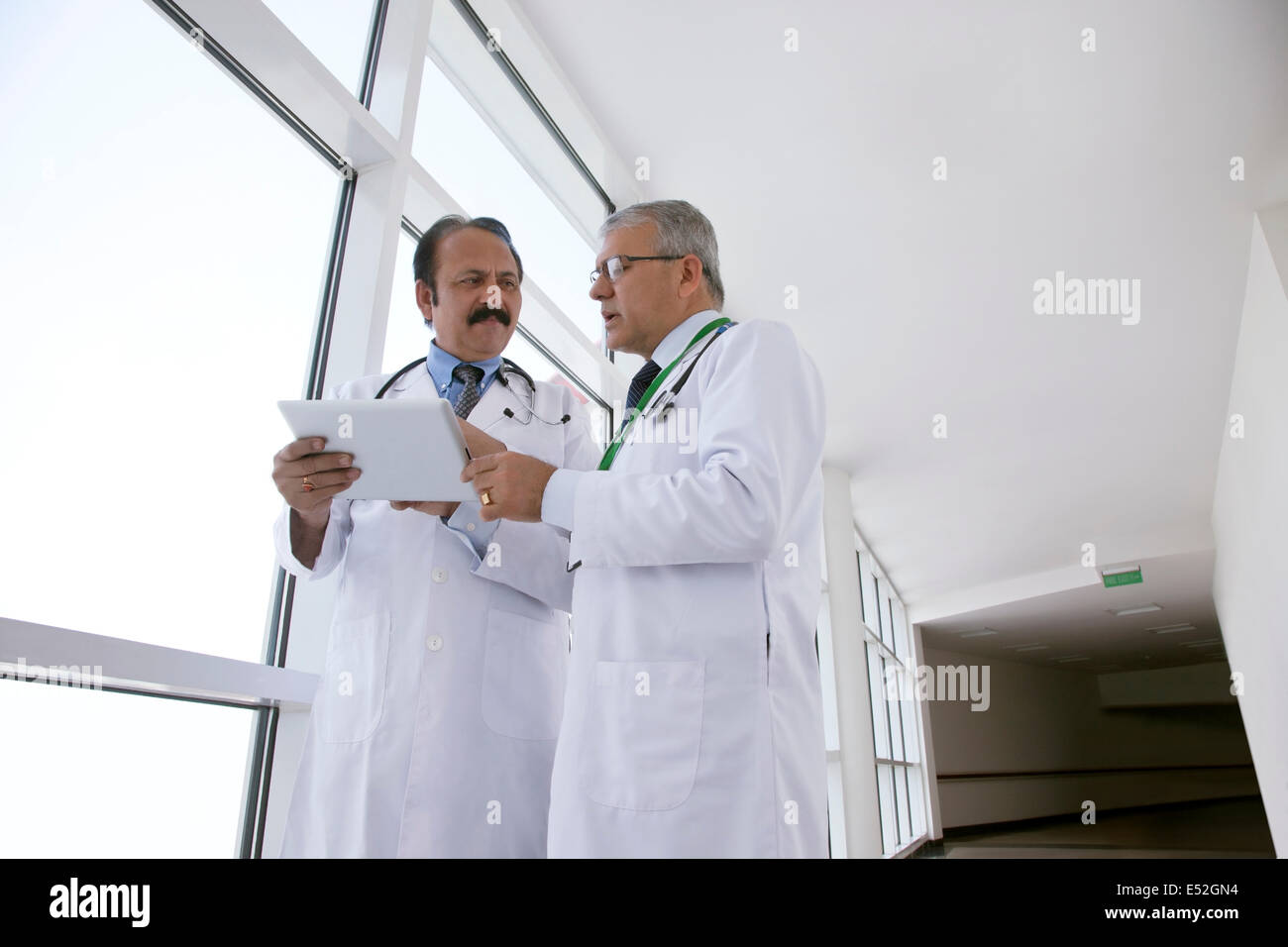 Two doctors with a digital tablet Stock Photo - Alamy