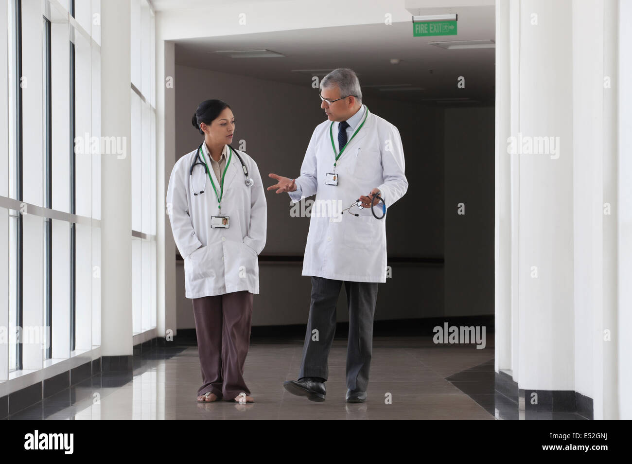 Two doctors talking in corridor of hospital Stock Photo - Alamy