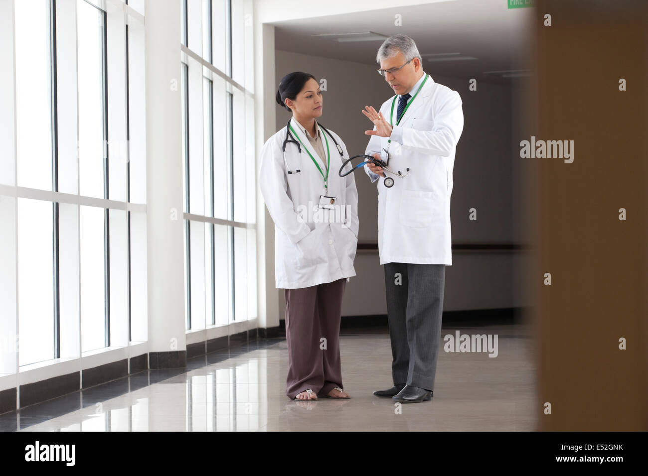 Two doctors talking in corridor of hospital Stock Photo - Alamy