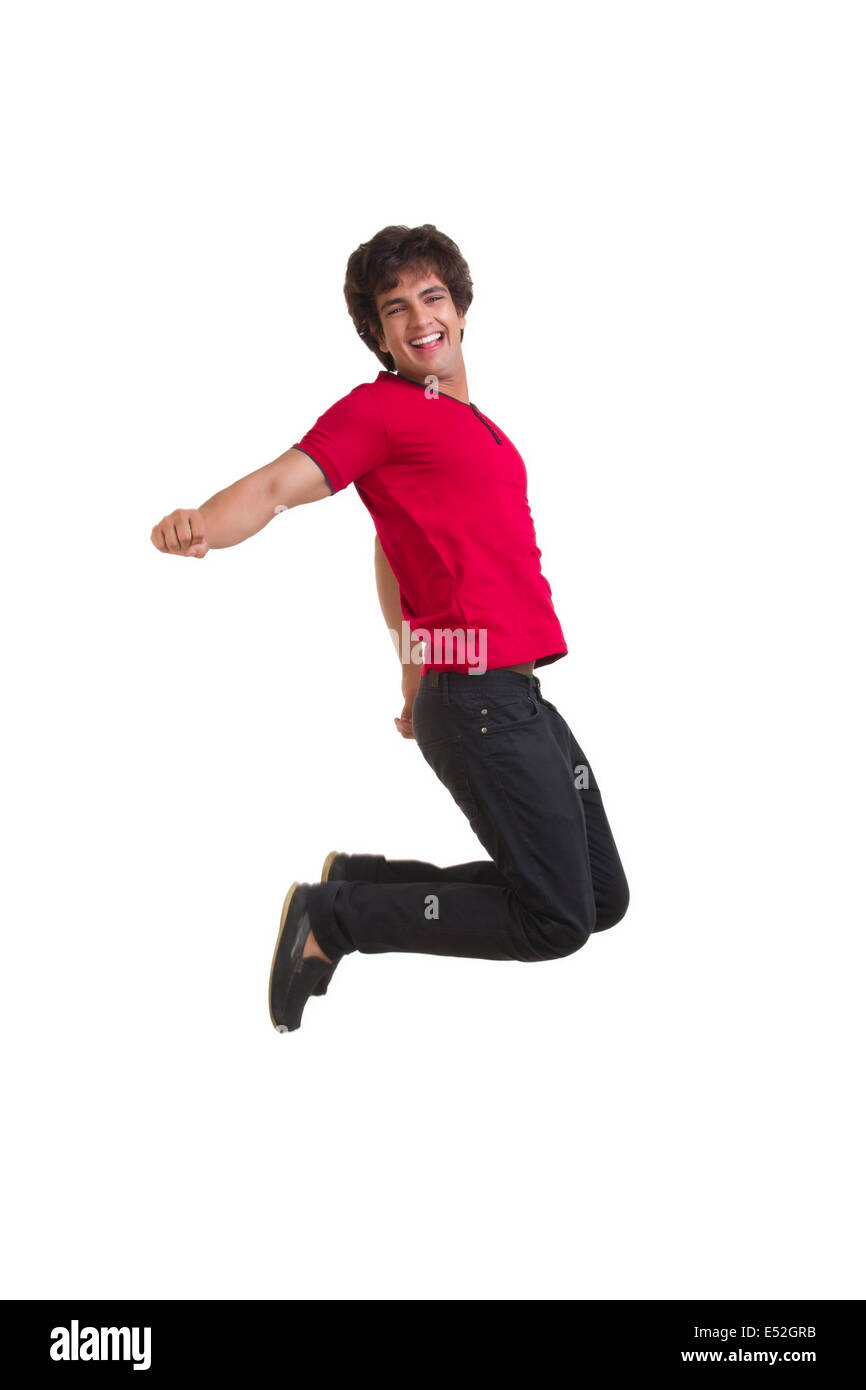 Full length of excited young man jumping isolated over white background ...