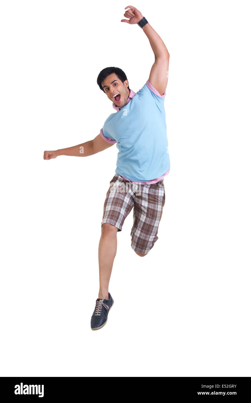 Full length of young man jumping isolated over white background Stock ...