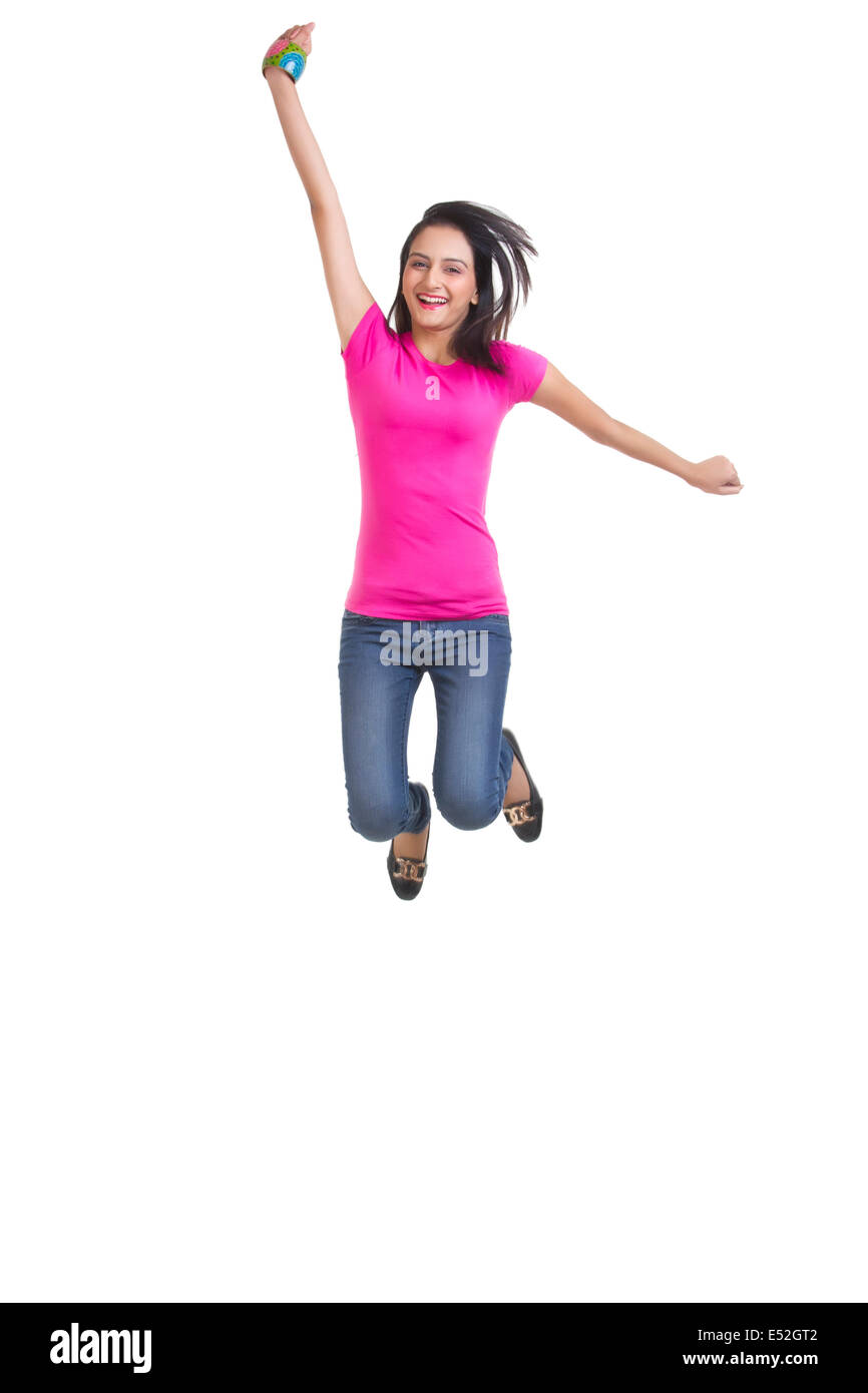 Full length portrait of happy young woman jumping over white background ...