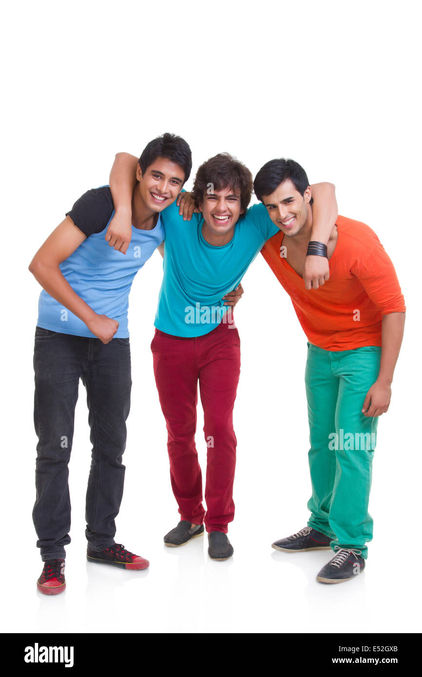 Full length of three male friends smiling together over white ...